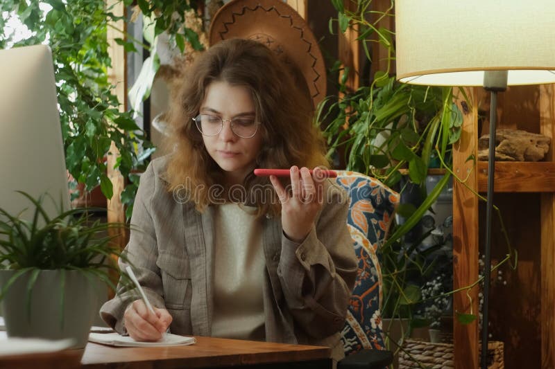 Employee Talking on Mobile Phone Using Speaker Mode Taking Notes ...