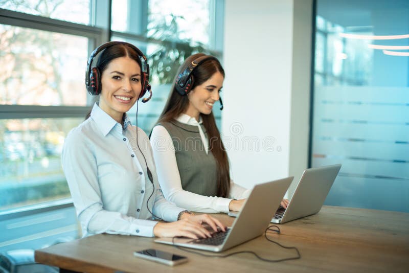 Female Employee Workers Wearing Headset Sitting on Table Using Laptop ...