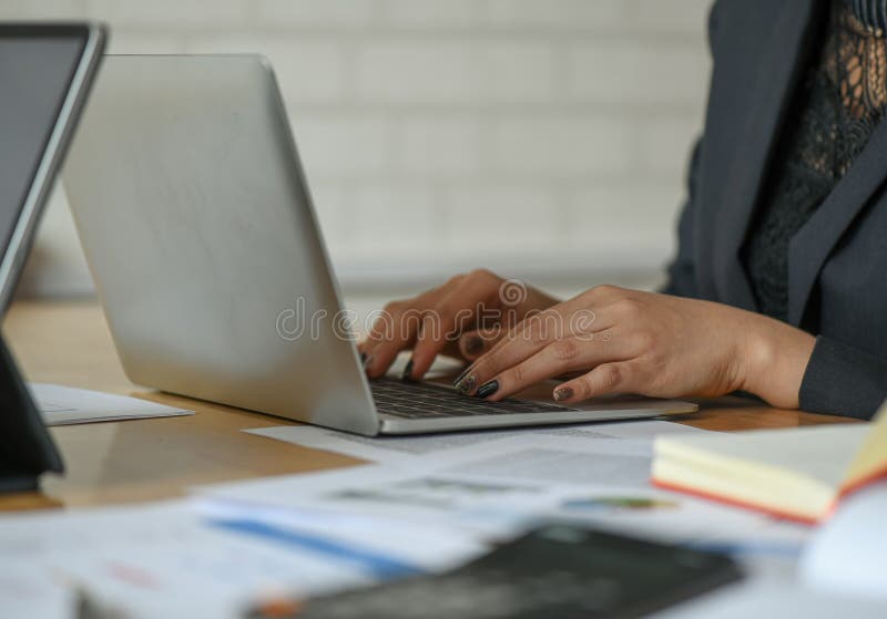 Female Employees are Using a Laptop on the Desk in the Office Stock ...