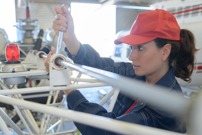 Female Engineer Adjusting Metal Frame Stock Photo - Image of tough ...