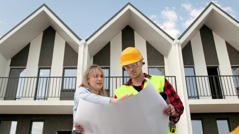 Team of Construction Professionals Viewing Blueprints on Job Site Stock ...