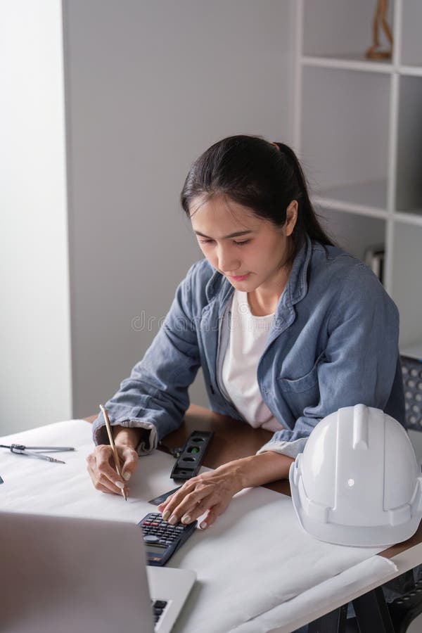 Female Engineer Calculating Project Costs in Office Stock Photo - Image of industry, expertise ...
