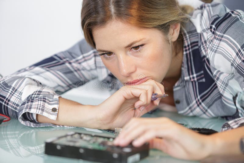 Female Engineer Examining Broken Computer Hard Drive Stock Photo ...