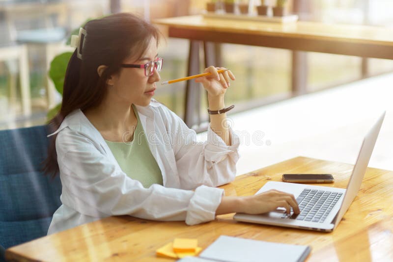 Female Engineer with Eyeglasses Pensive Thinking on Laptop Stock Photo ...