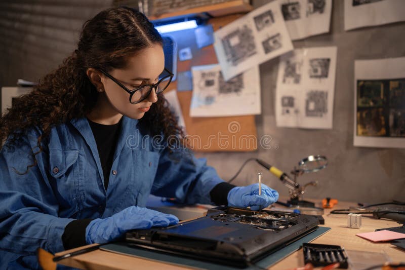 Female Engineer Fixing Broken Computer Motherboard in Workshop. Laptop ...