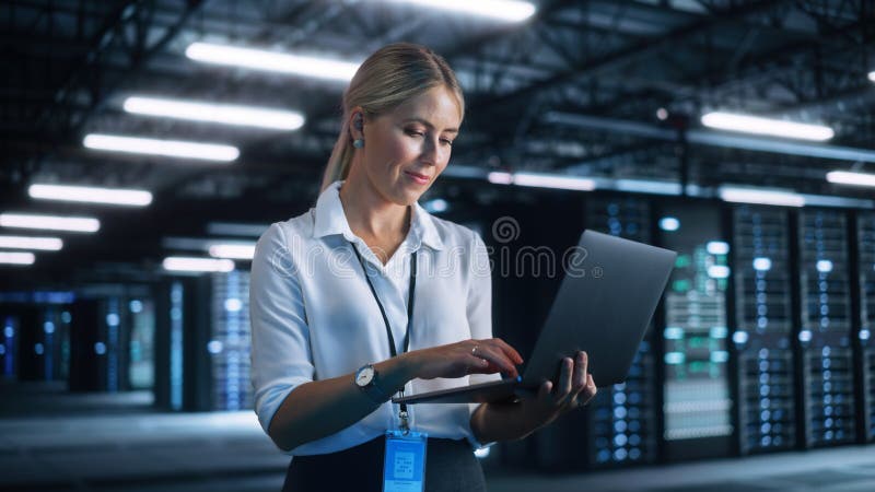 Female Engineer Holding Laptop Computer at Hands while Programs ...