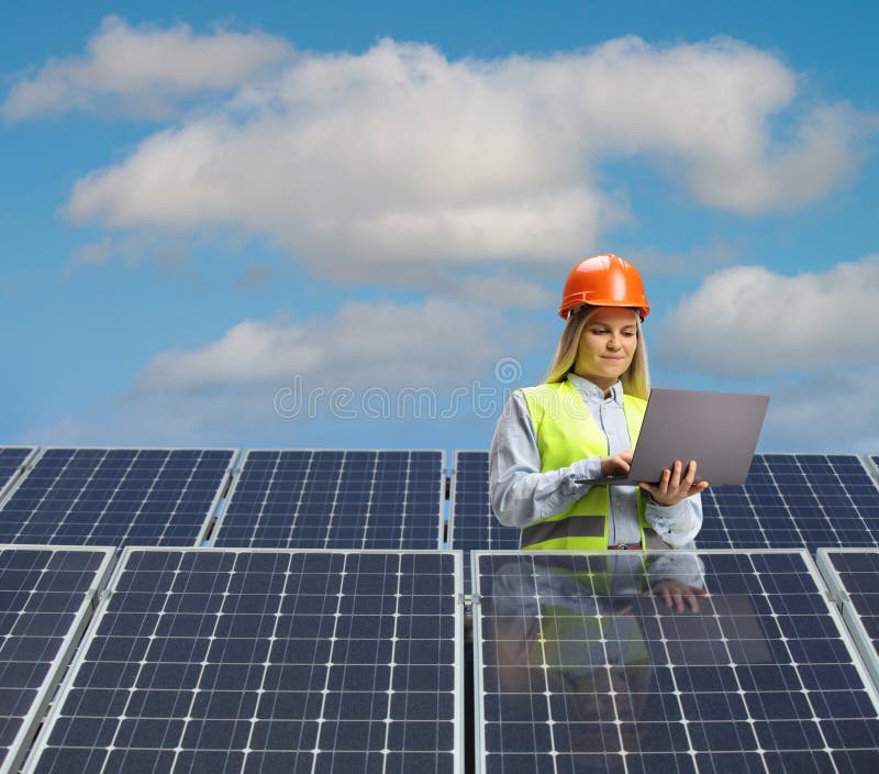 Female Engineer with a Laptop Computer Standing between Solar Panels ...