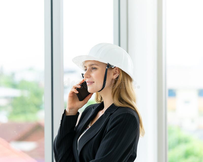 Female Engineer Making Call in Office Building Stock Image - Image of ...