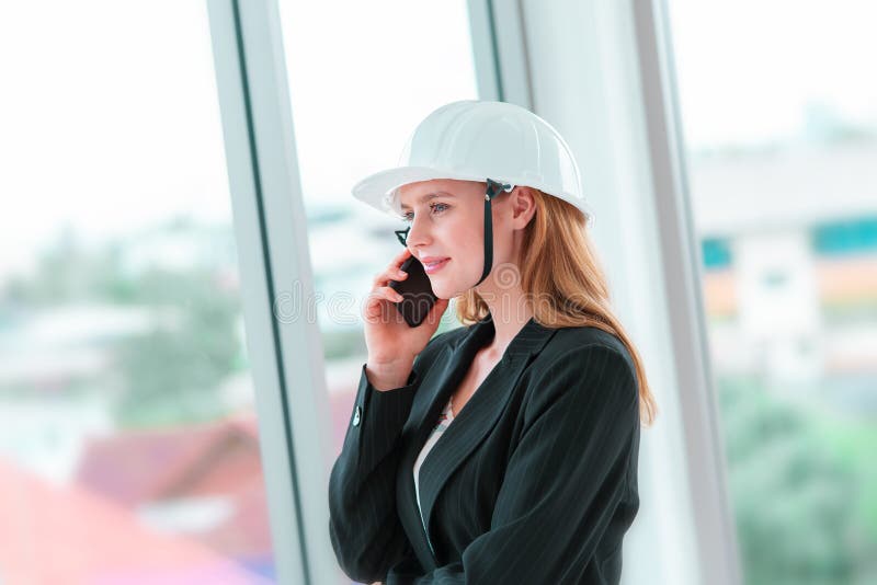 Female Engineer Making Call in Office Building Stock Photo - Image of ...