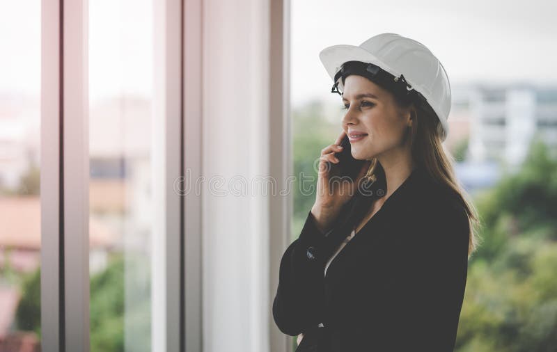 Female Engineer Making Call in Office Building Stock Photo - Image of ...