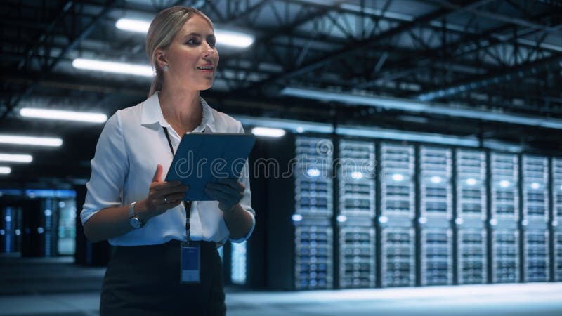 Female Engineer Programs Something while Holding Tablet Computer in ...