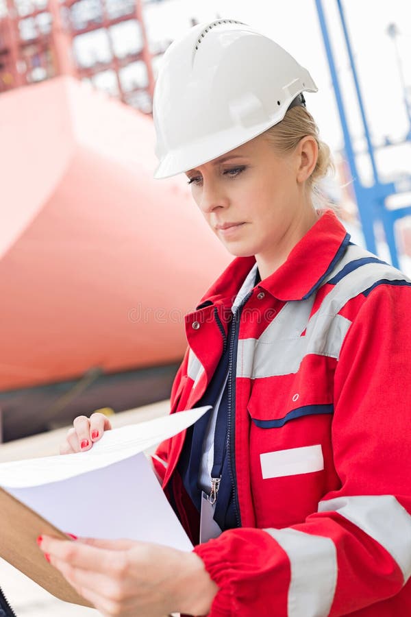 Female Engineer Reading Documents in Shipping Yard Stock Image - Image ...