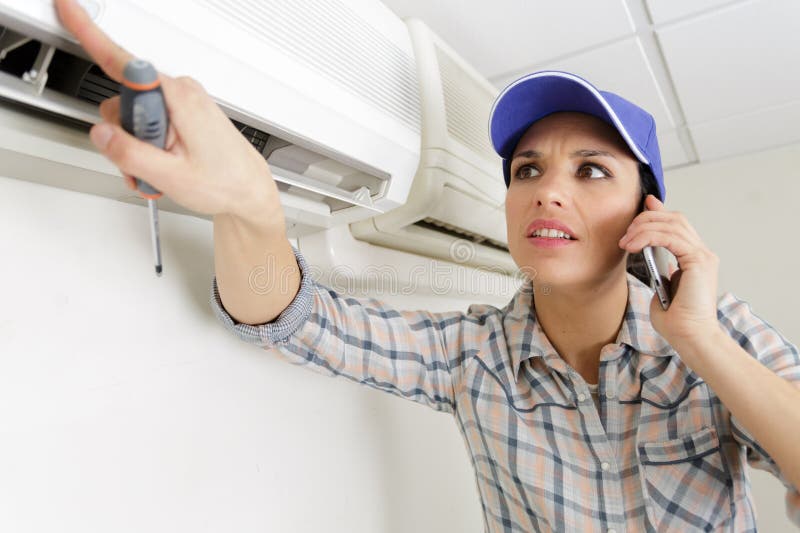 Female Engineer Repairing Air Conditioning System Calling for Help Stock Image - Image of adult ...