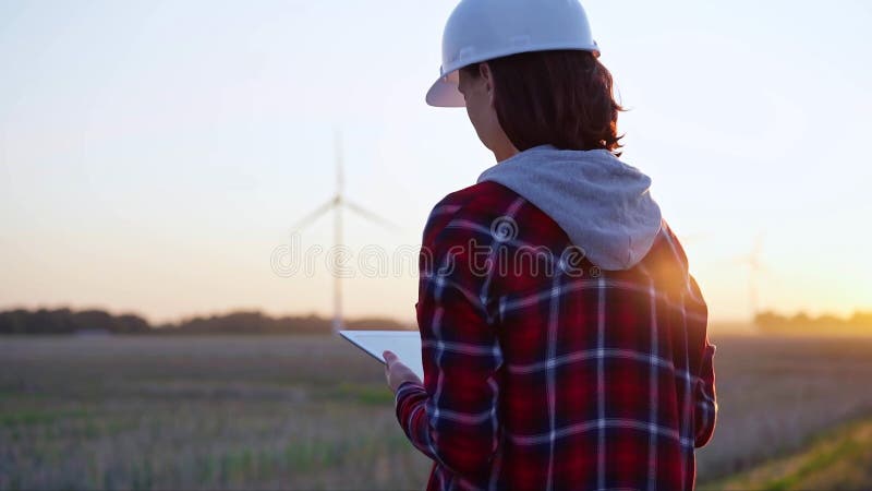 Female Engineer Taking Notes with a Tablet Computer on a Field with ...