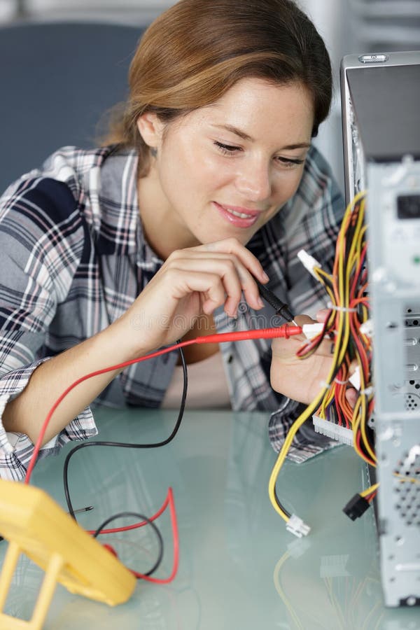 Female Engineer Testing Computer with Multimeter Stock Photo - Image of ...