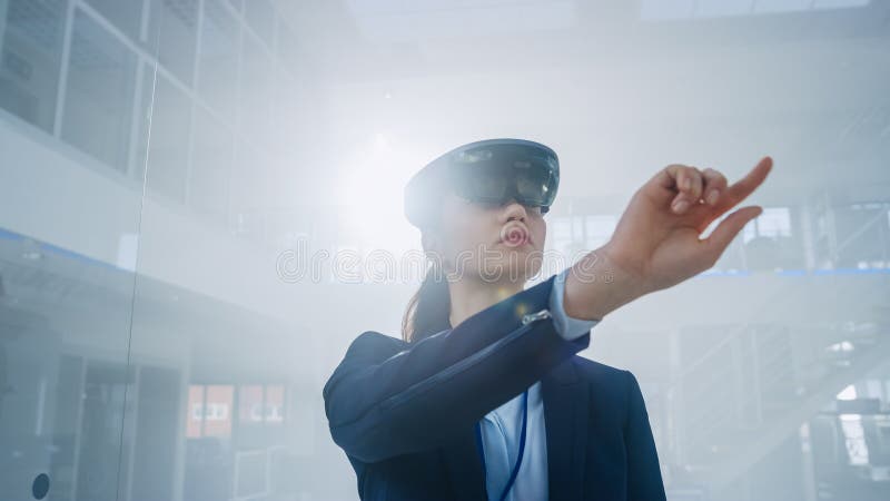 Female Engineer Using Augmented Reality Headset Pushes Virtual Buttons ...