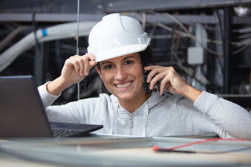 Female Engineer Using Laptop and Telephone in Roof-space Stock Image ...