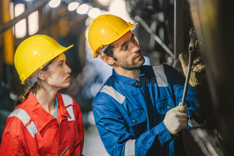 Female Engineer and Worker Checking Equipment in Factory for Repair ...