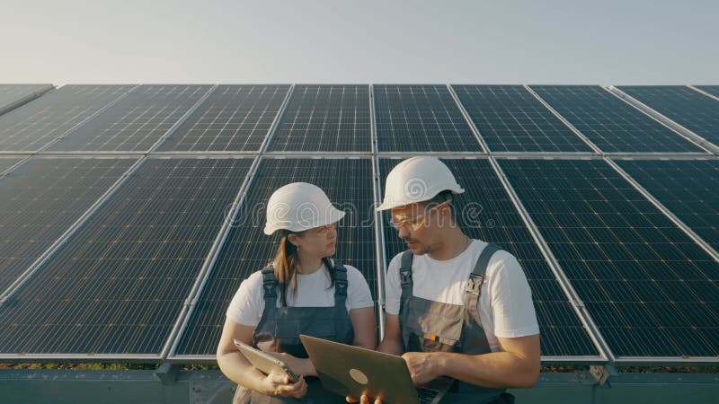 An Engineer and His Assistant Check the Operation of Solar Panels Stock ...