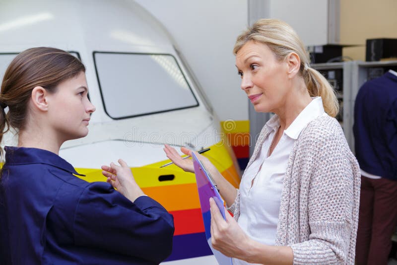 Female Engineers Talking about Airplane Stock Photo - Image of ...