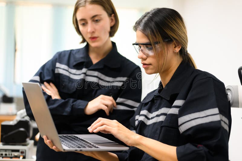 Female Engineers Using Laptop Checking and Operating Robotic Machine Stock Image - Image of ...