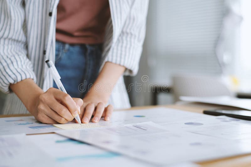 Female Entrepreneur Writing Down Figures Stock Image - Image of ...