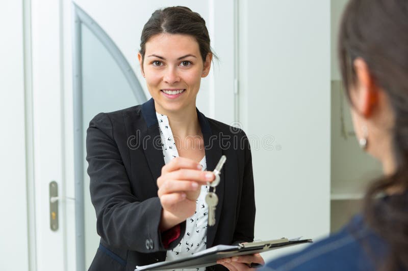 Female Estate Agent Passing Keys To Customer Stock Image - Image of ...