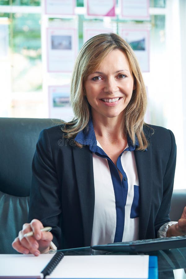 Female Estate Agent Working at Computer in Office Stock Photo - Image ...