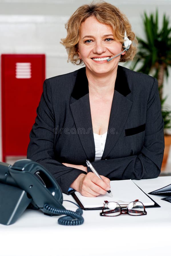 Female Executive Assisting Customers on Call Stock Image - Image of ...