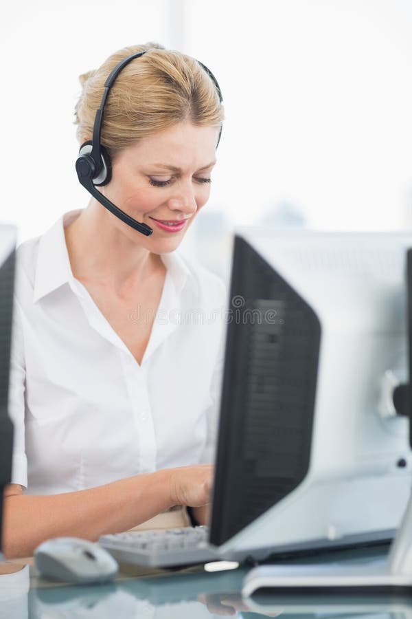 Female Executive with Headset Using Computer at Desk Stock Photo ...