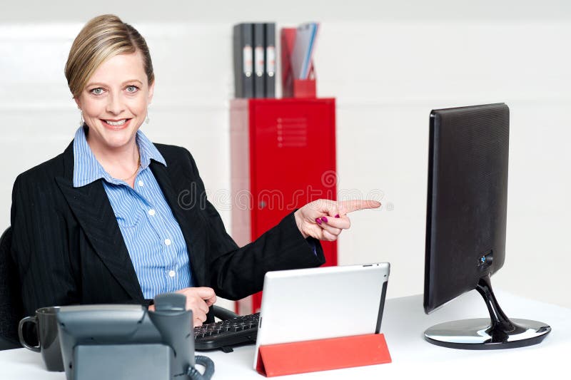Female Executive Pointing at Computer Screen Stock Photo - Image of ...