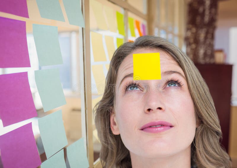 Female Executive with Sticky Note on Head in Office Stock Photo - Image ...