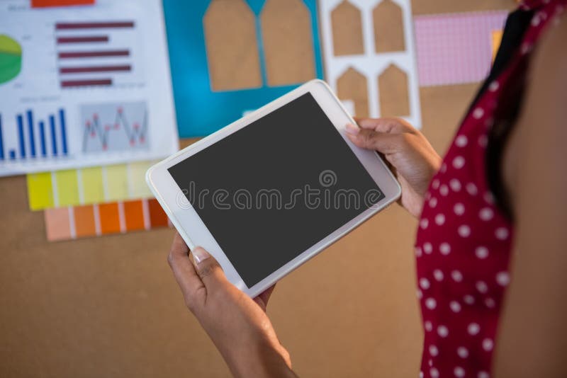 Female Executive Using Digital Tablet Near Bulletin Board in Office ...