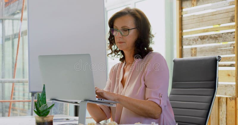 Female Executive Using Laptop at the Desk in Office 4k Stock Image ...