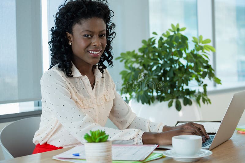 Female Executive Using Laptop at Desk in Office Stock Photo - Image of ...