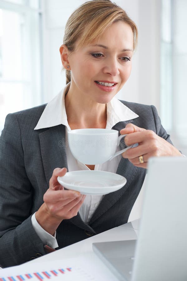Female Executive Working at Desk with Hot Drink Stock Image - Image of ...