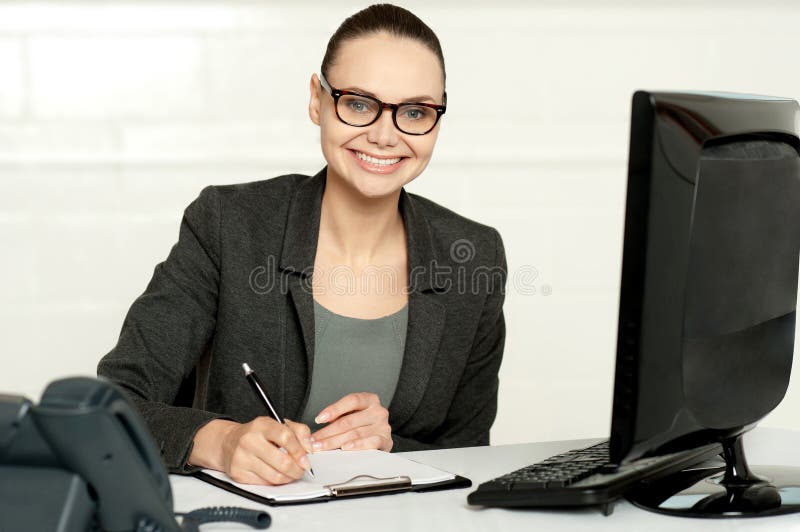Female Executive Writing on Notepad Stock Image - Image of desk ...