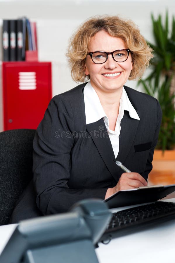 Female Executive Writing Notes on Clipboard Stock Photo - Image of ...