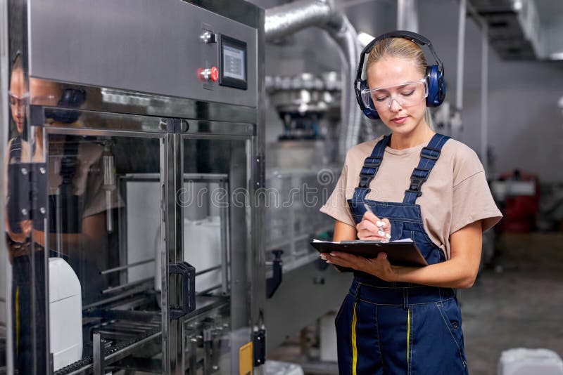 Female Factory Worker Hold Quality Control at Work, Take Notes into ...