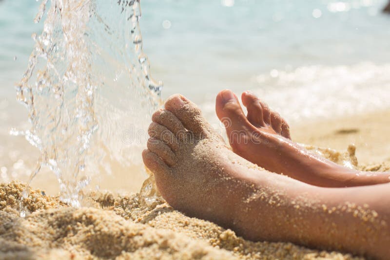 Woman feet on the beach stock photo. Image of summer - 11373270