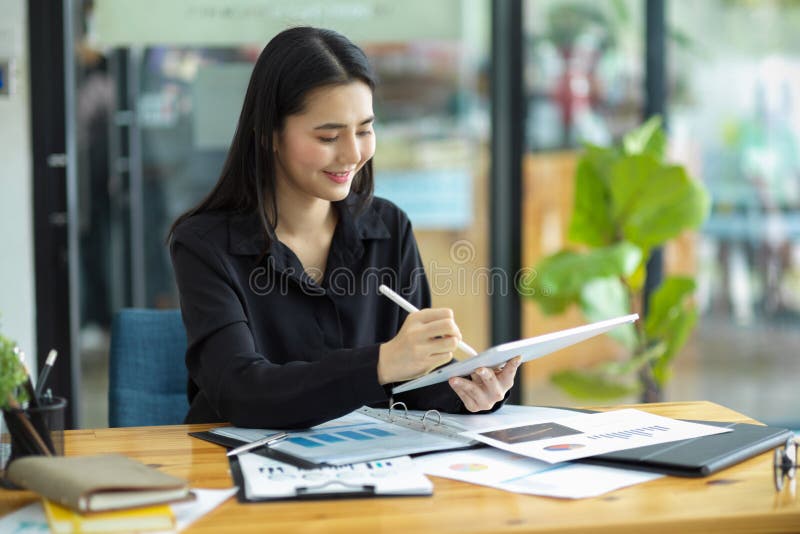 A Female Financial Assistant Taking Some Notes on a Tablet Stock Image ...