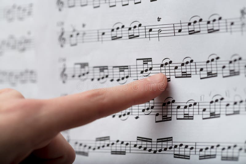 Female Finger Following the Notes on a Music Score Stock Photo - Image ...