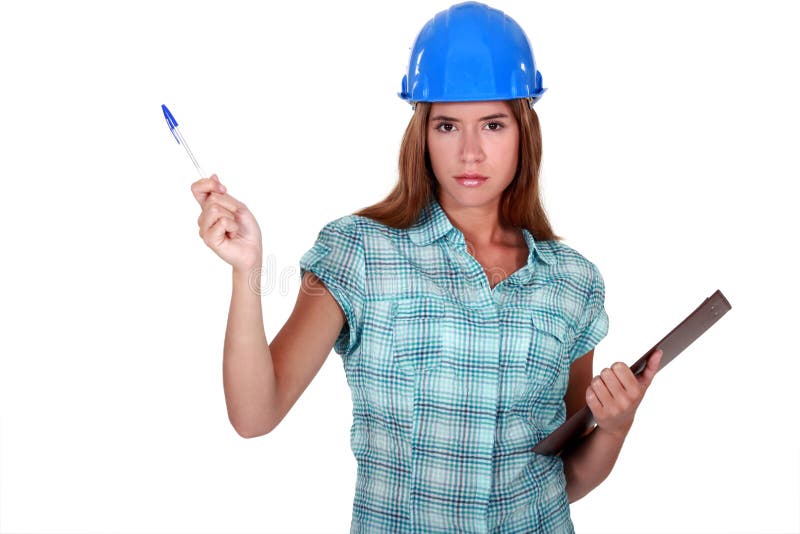 Female Foreman in a Protective Helmet and a Yellow Vest Checks the ...