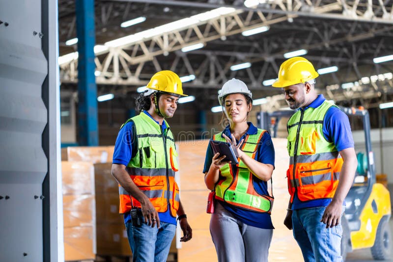 Female Foreperson Making Plans with Warehousemen, Workers Working in ...