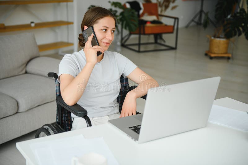 Female Freelance Programmer Sitting In Wheelchair And Using Computers While Coding Web Game At