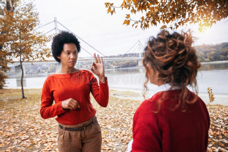Female Friends Deaf Talking with Nonverbal Communication Outdoor Stock ...