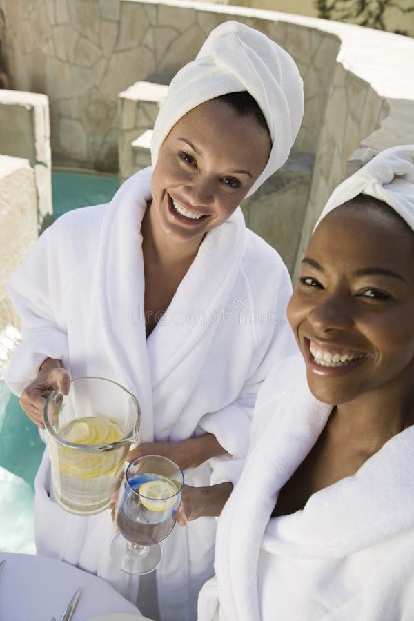 Female Friends Holding Pitcher and Glass Stock Photo - Image of aged ...