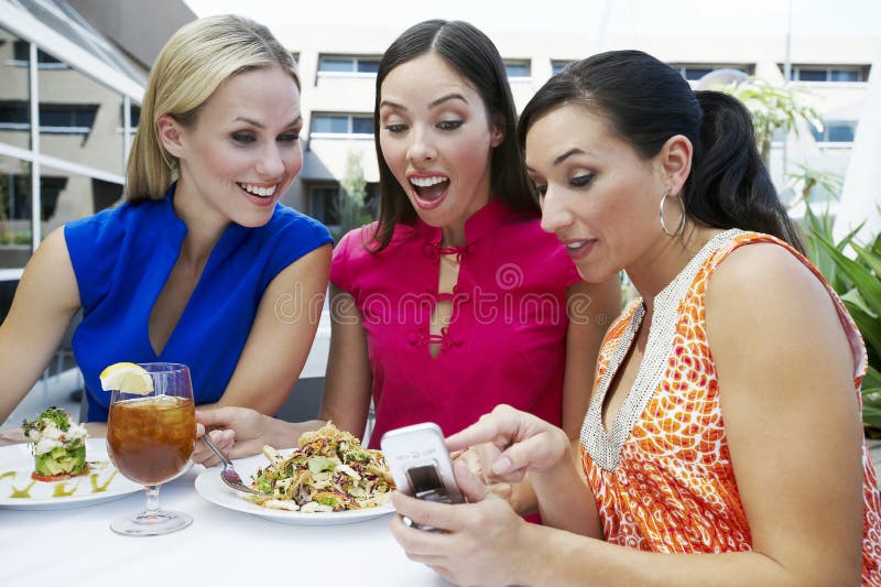 Female Friends Reading Text Message Stock Image - Image of food, casual ...