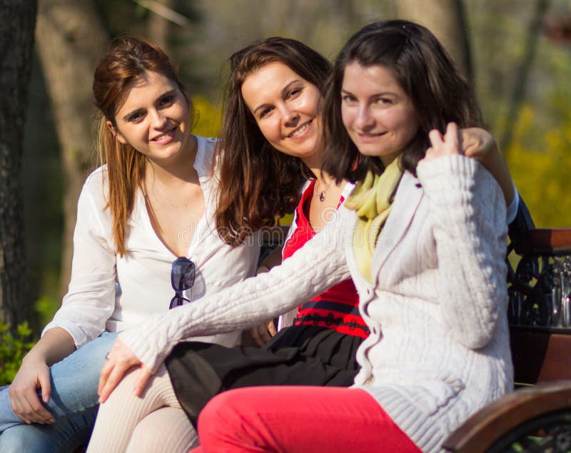 Female Friends Sitting on a Bench Stock Image - Image of sitting, mates ...