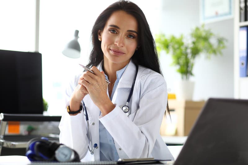 Female GP Sitting at Worktable in Office Stock Photo - Image of ...